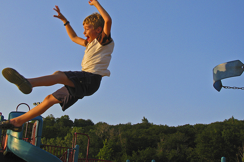 boy-jumping-from-swing-playgrounds-swingset – Gymnastics Coaching.com
